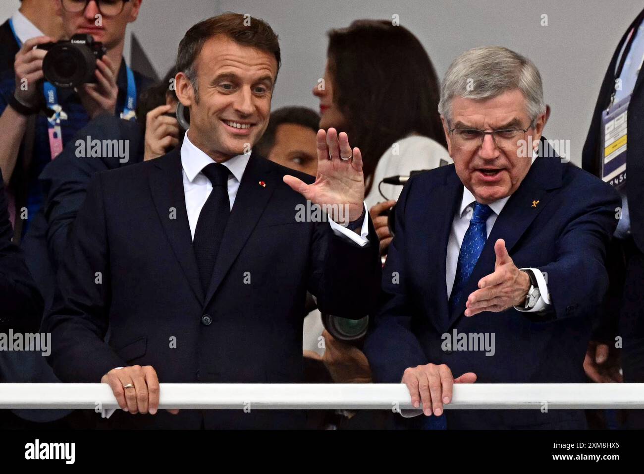 France's President Emmanuel Macron, left, and IOC President Thomas Bach ...