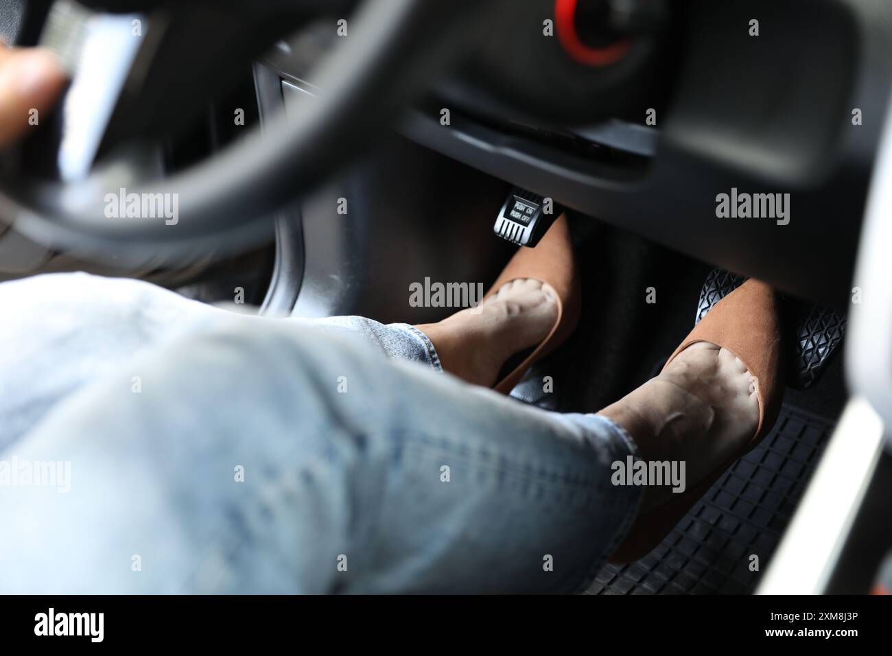 Woman in high heels pushing on pedal of car brake, closeup Stock Photo ...