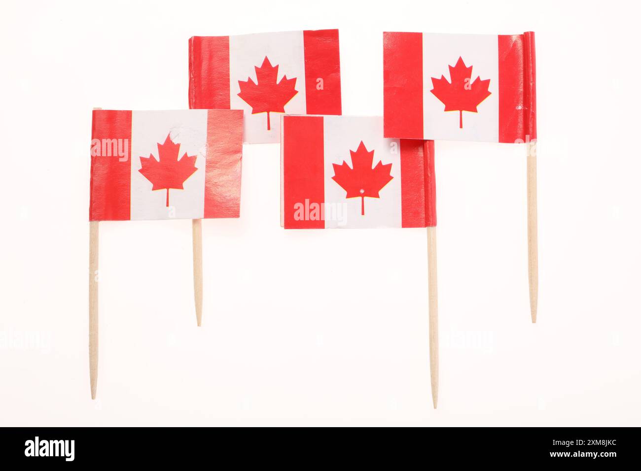Small paper flags of Canada isolated on white Stock Photo - Alamy