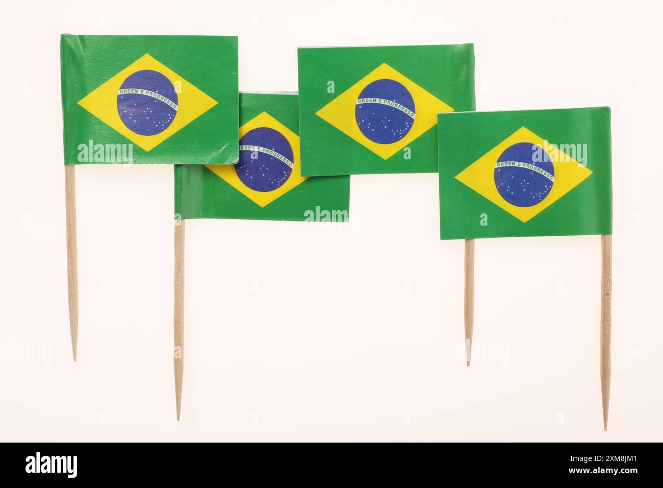 Small paper flags of Brazil isolated on white Stock Photo - Alamy