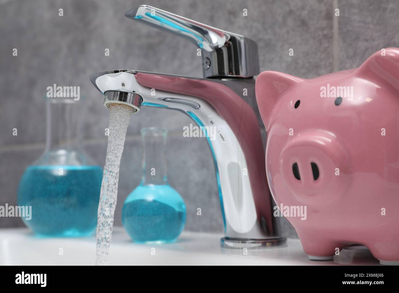 Water saving concept. Piggy bank, glassware with liquid and stream of ...