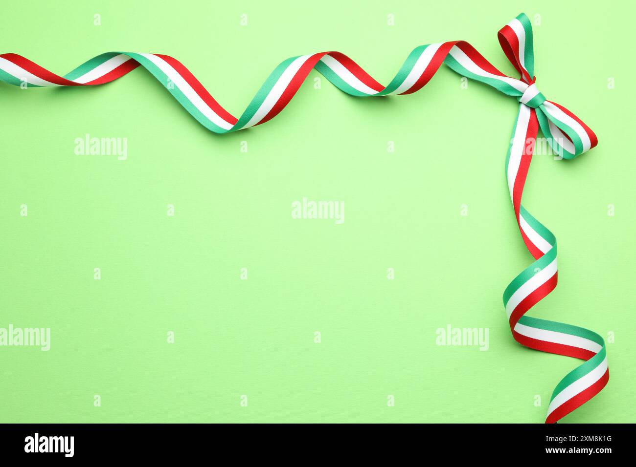 Ribbon with bow in colors of Hungarian flag on green background, top ...