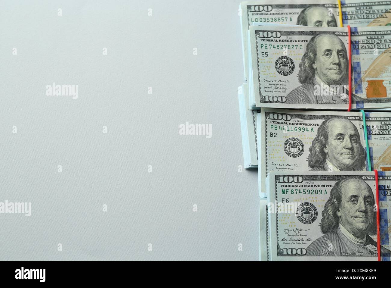 Bundles of dollar banknotes on light grey background, above view. Space ...