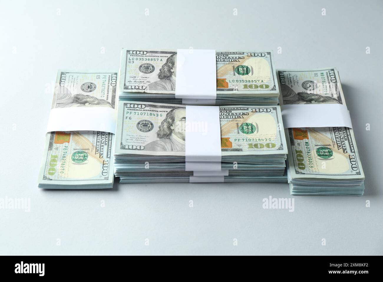 Bundles of dollar banknotes on light grey background Stock Photo - Alamy