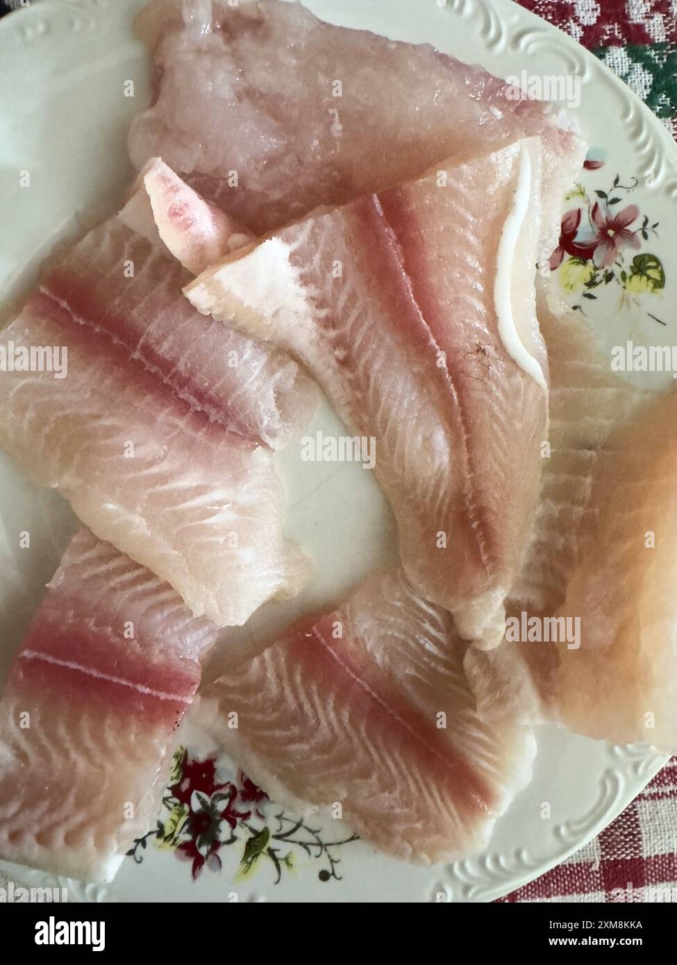 Fresh raw fish fillets on a decorative plate, ready for cooking and ...