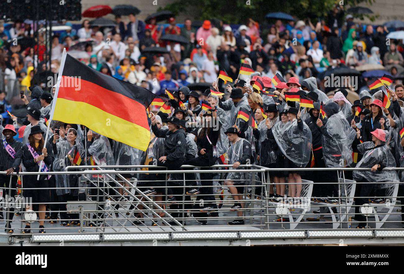 Athletes in the delegation of Germany ride in a boat along the Seine ...