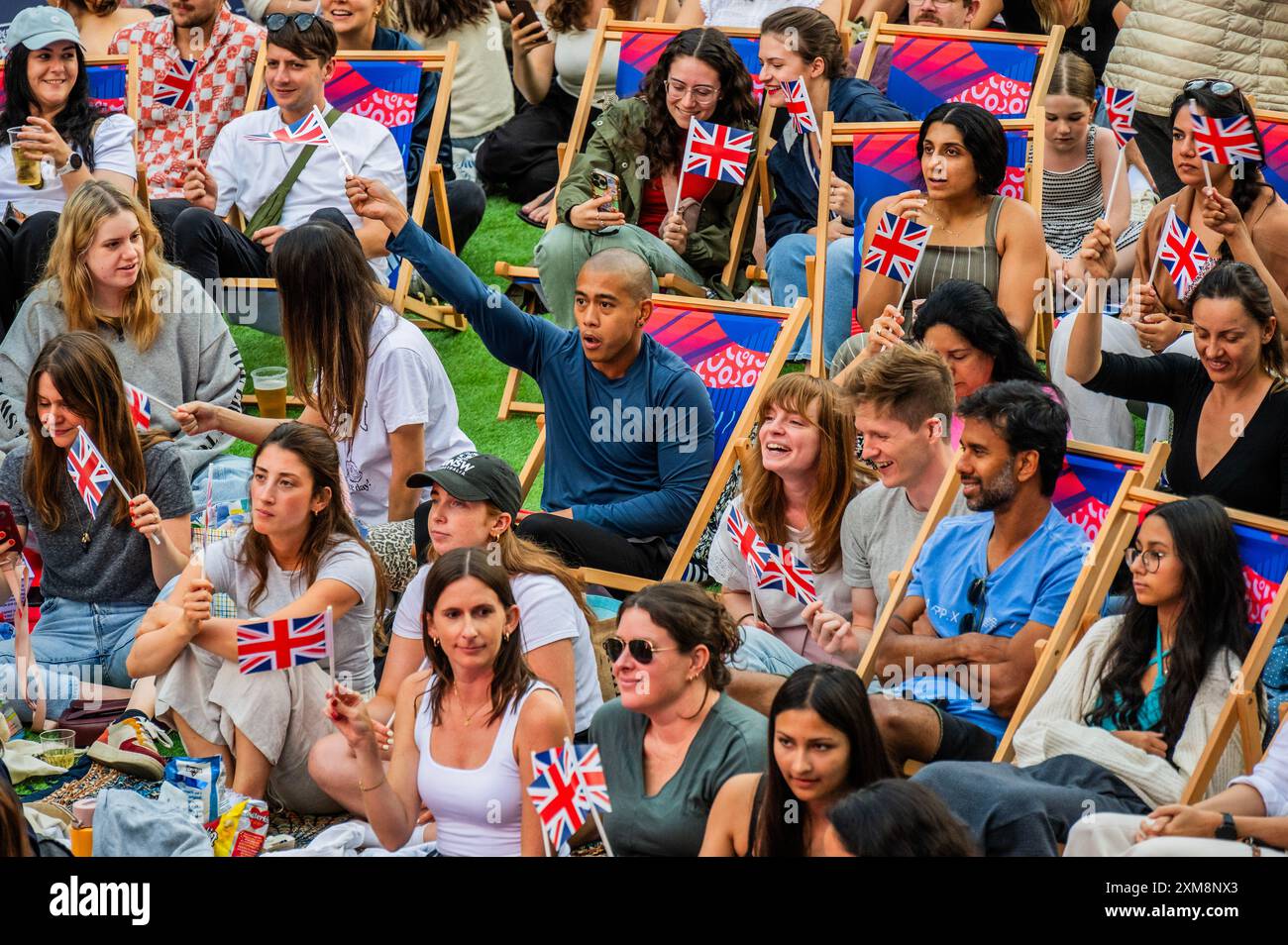 London, UK. 26th July, 2024. Union Jack flags are handed out - A large ...