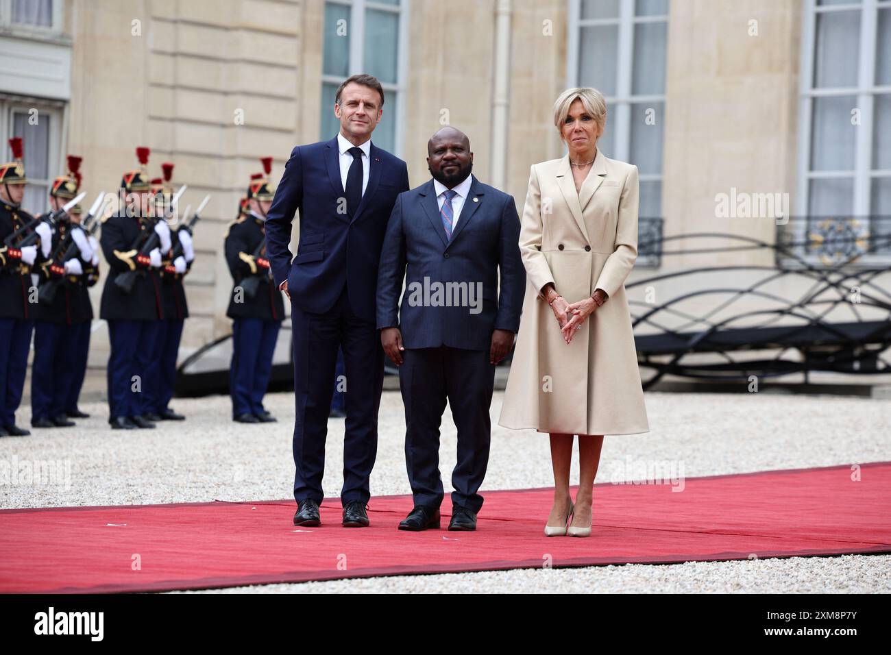 French President Emmanuel Macron, guest and Brigitte Macron attending ...
