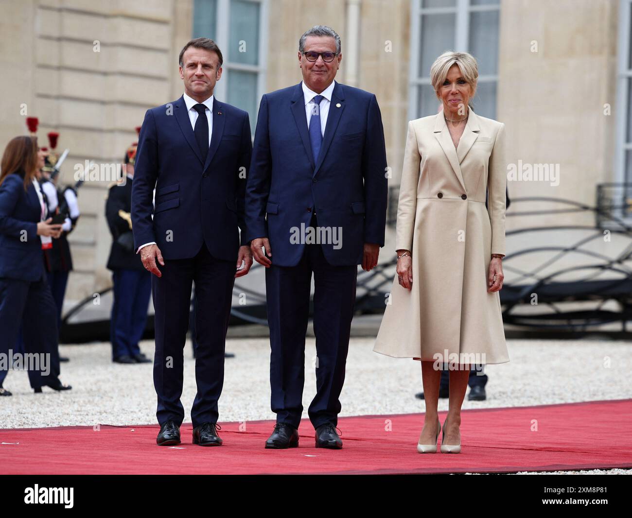 French President Emmanuel Macron, guest and Brigitte Macron attending ...
