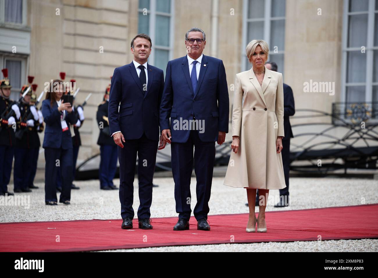 French President Emmanuel Macron, guest and Brigitte Macron attending ...