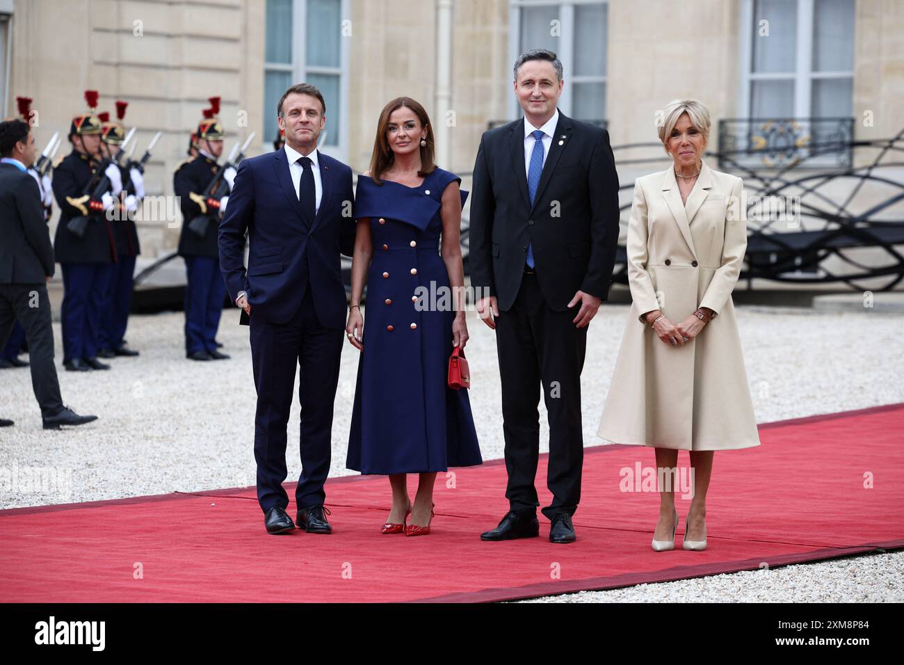 French President Emmanuel Macron, guest and Brigitte Macron attending ...