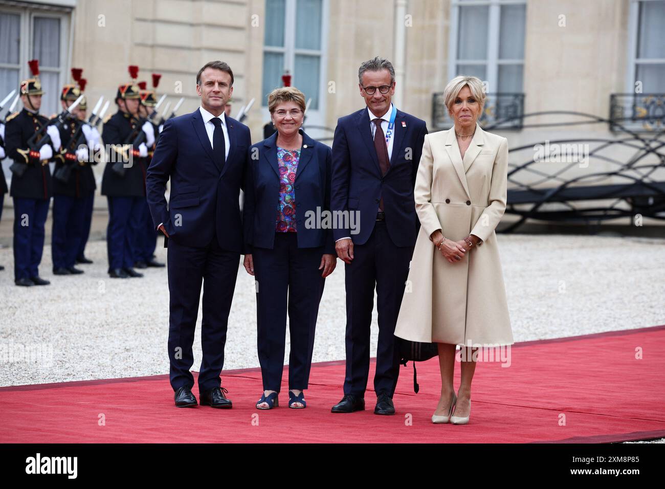 French President Emmanuel Macron, guest and Brigitte Macron attending ...