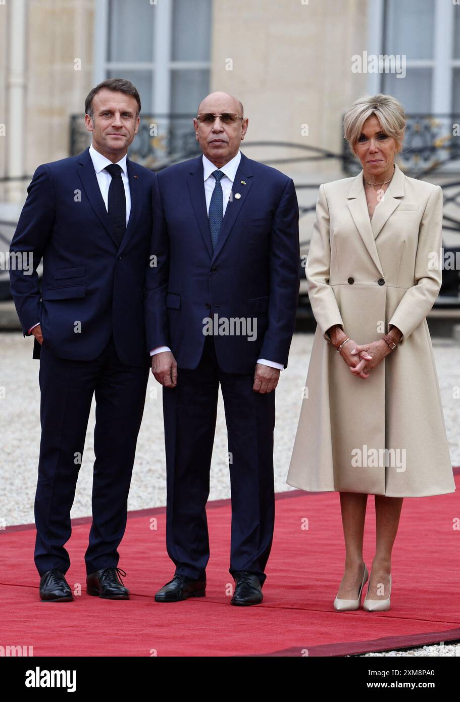 French President Emmanuel Macron, guest and Brigitte Macron attending ...