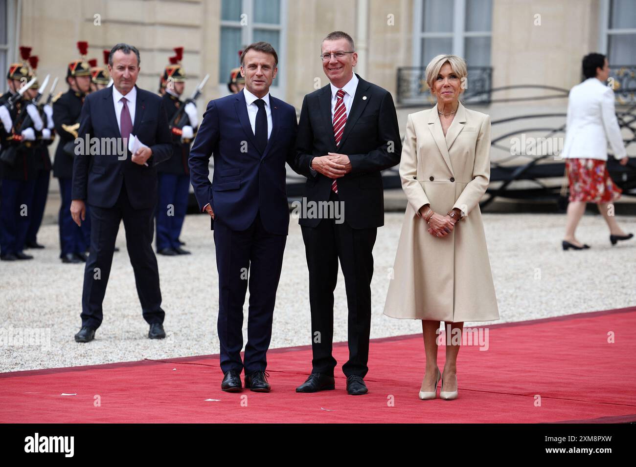 French President Emmanuel Macron, guest and Brigitte Macron attending ...