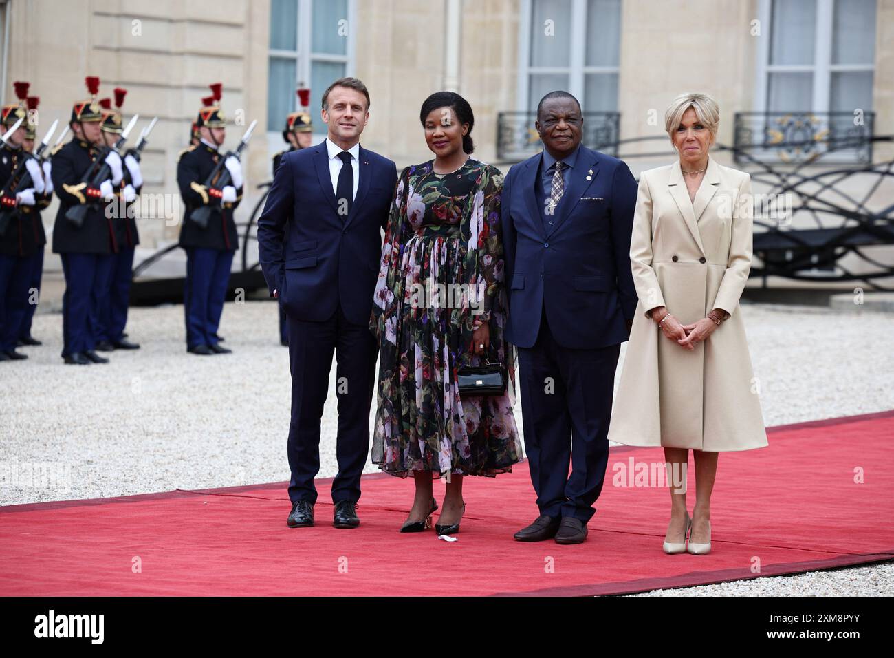 French President Emmanuel Macron, guest and Brigitte Macron attending ...