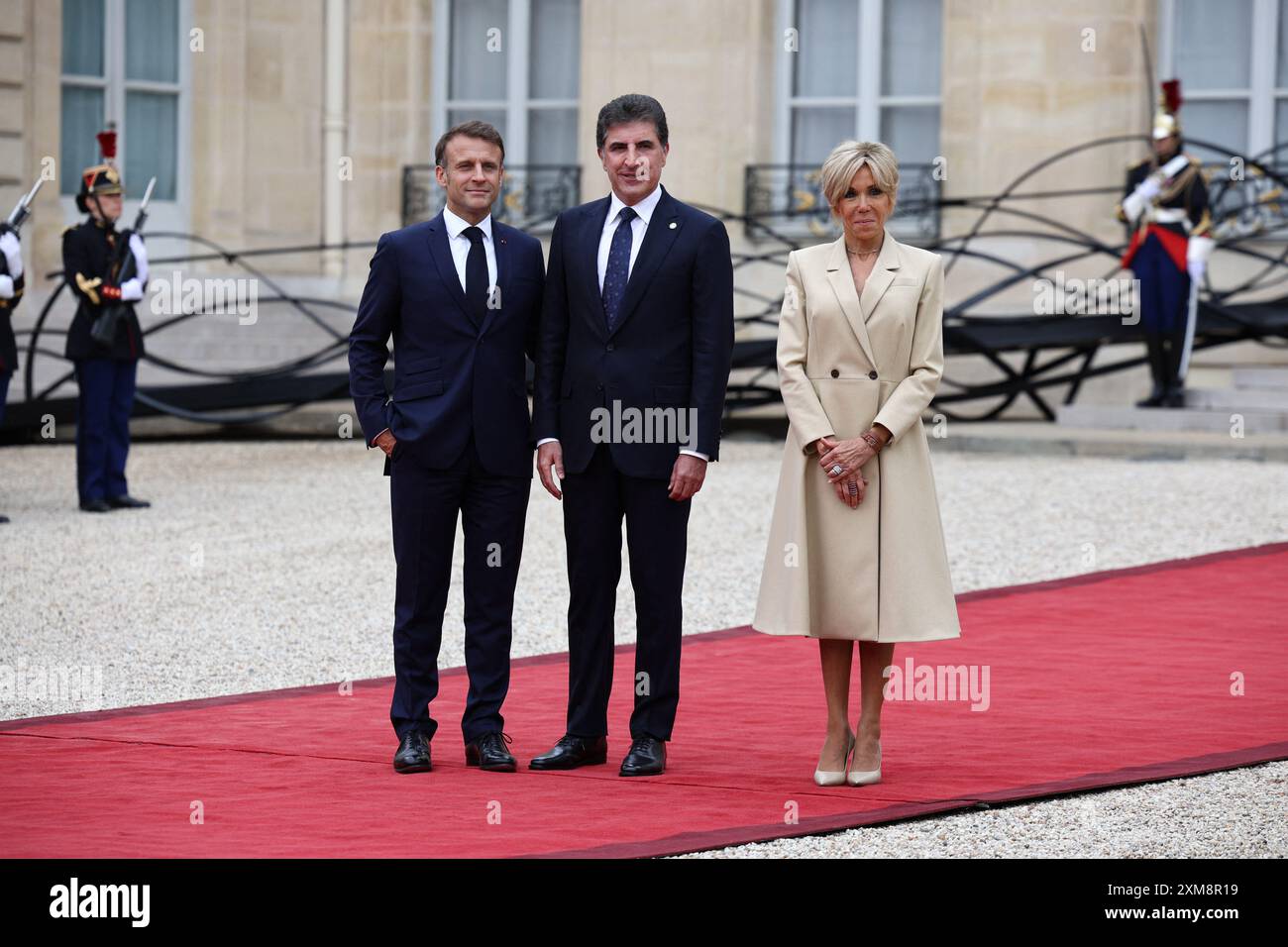 French President Emmanuel Macron, guest and Brigitte Macron attending ...