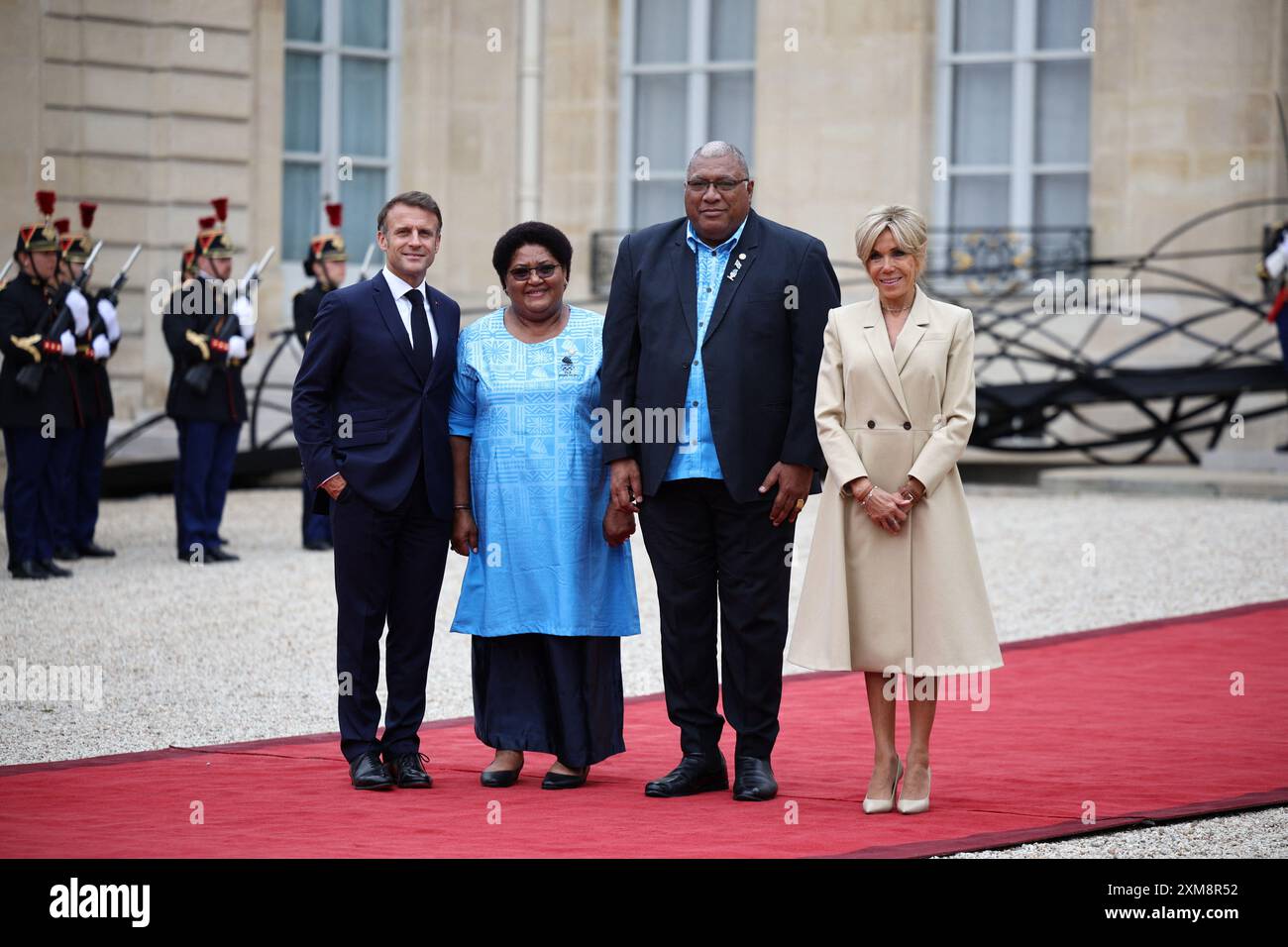 French President Emmanuel Macron, guest and Brigitte Macron attending ...