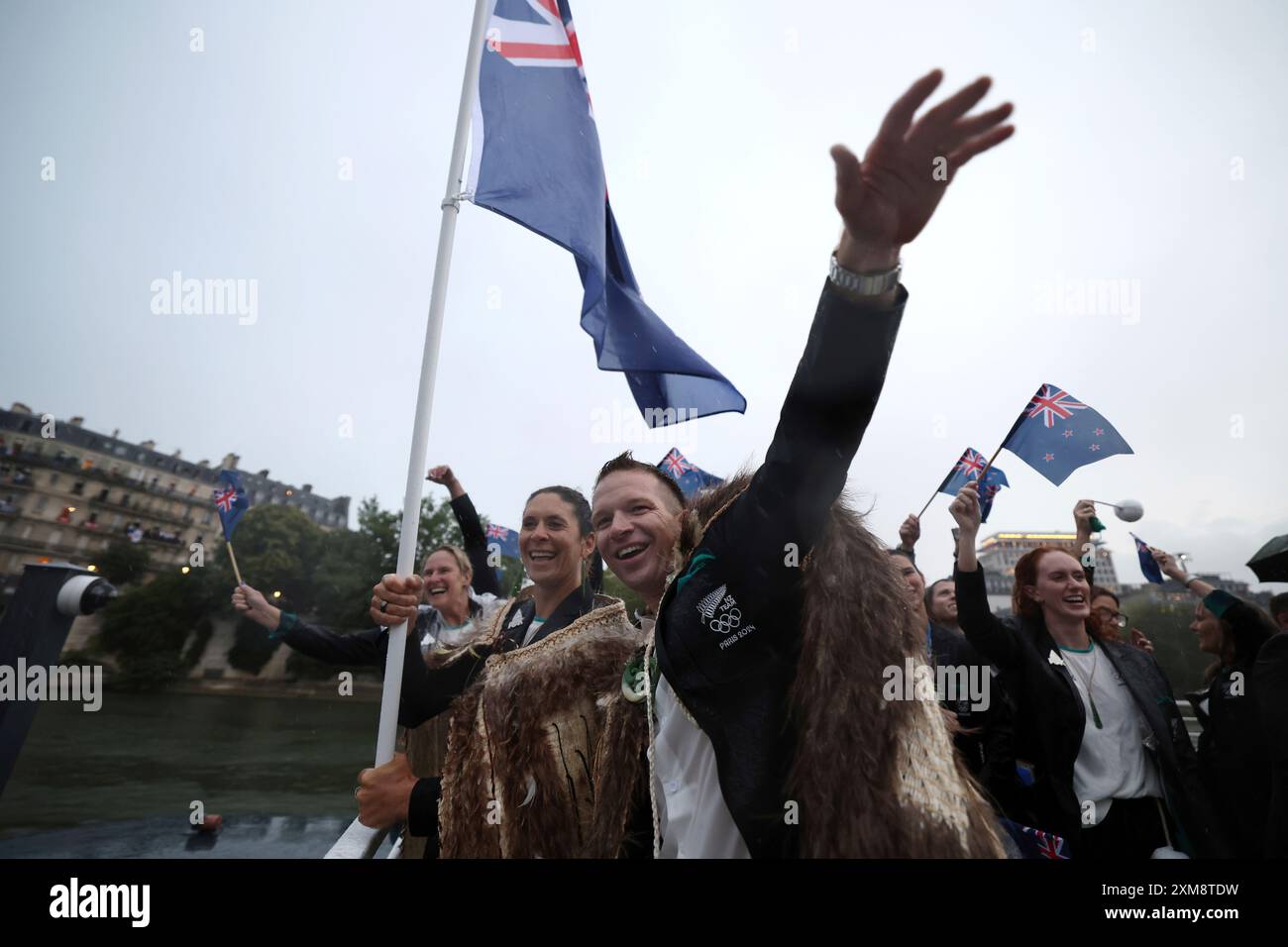 Jo Aleh and Aaron Murray Gate, Flagbearers of Team New Zealand, wave to ...