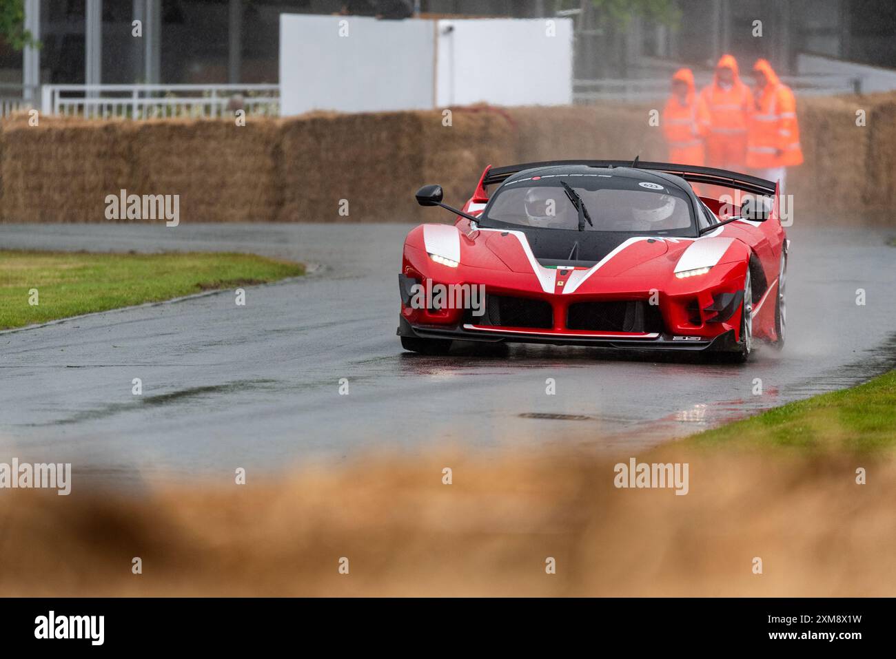 2019 Ferrari FXX-K Evo sports car driving up the wet hillclimb track in ...