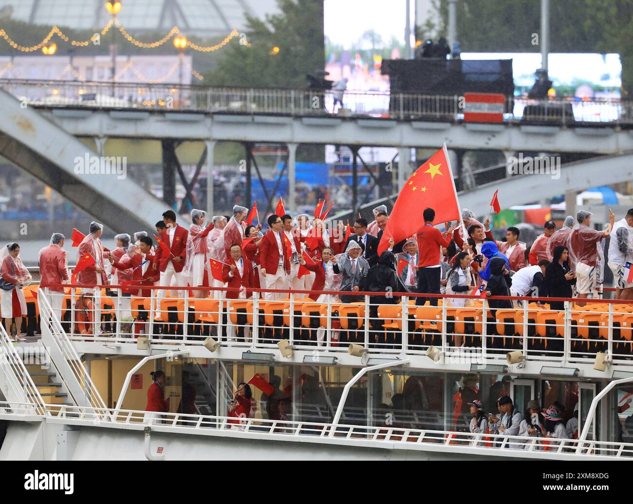 China's athletes aboard a boat sail the River Seine during the opening ...