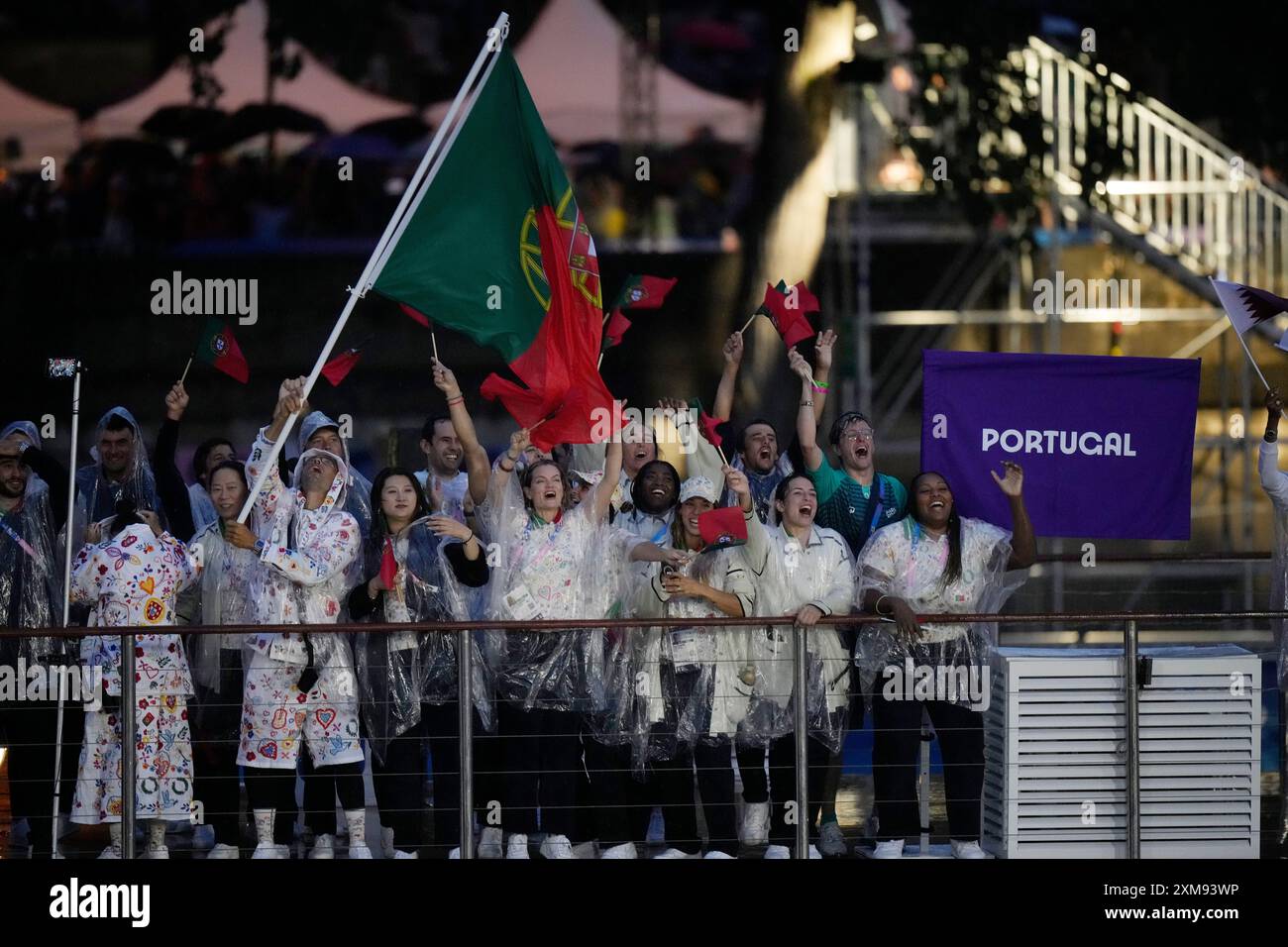 Portugal athletes wave from a boat on the Seine River in Paris, France ...