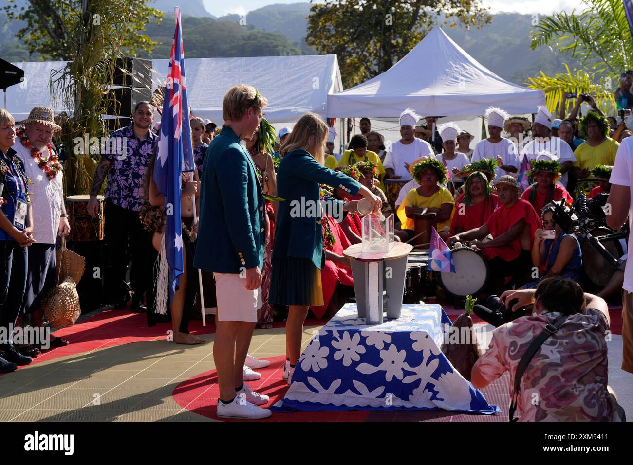 Surfer Molly Picklum, of Australia, pours sand from Australian during ...