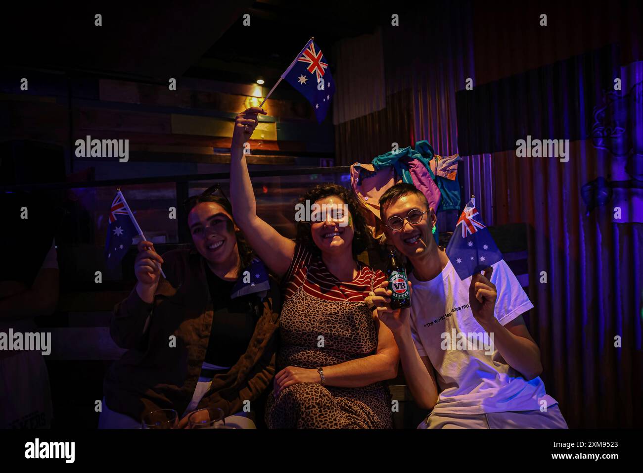Sophie Landells, Elyse Bogdan and Chakasaurus from Australia pose for a photo as they watch a ...