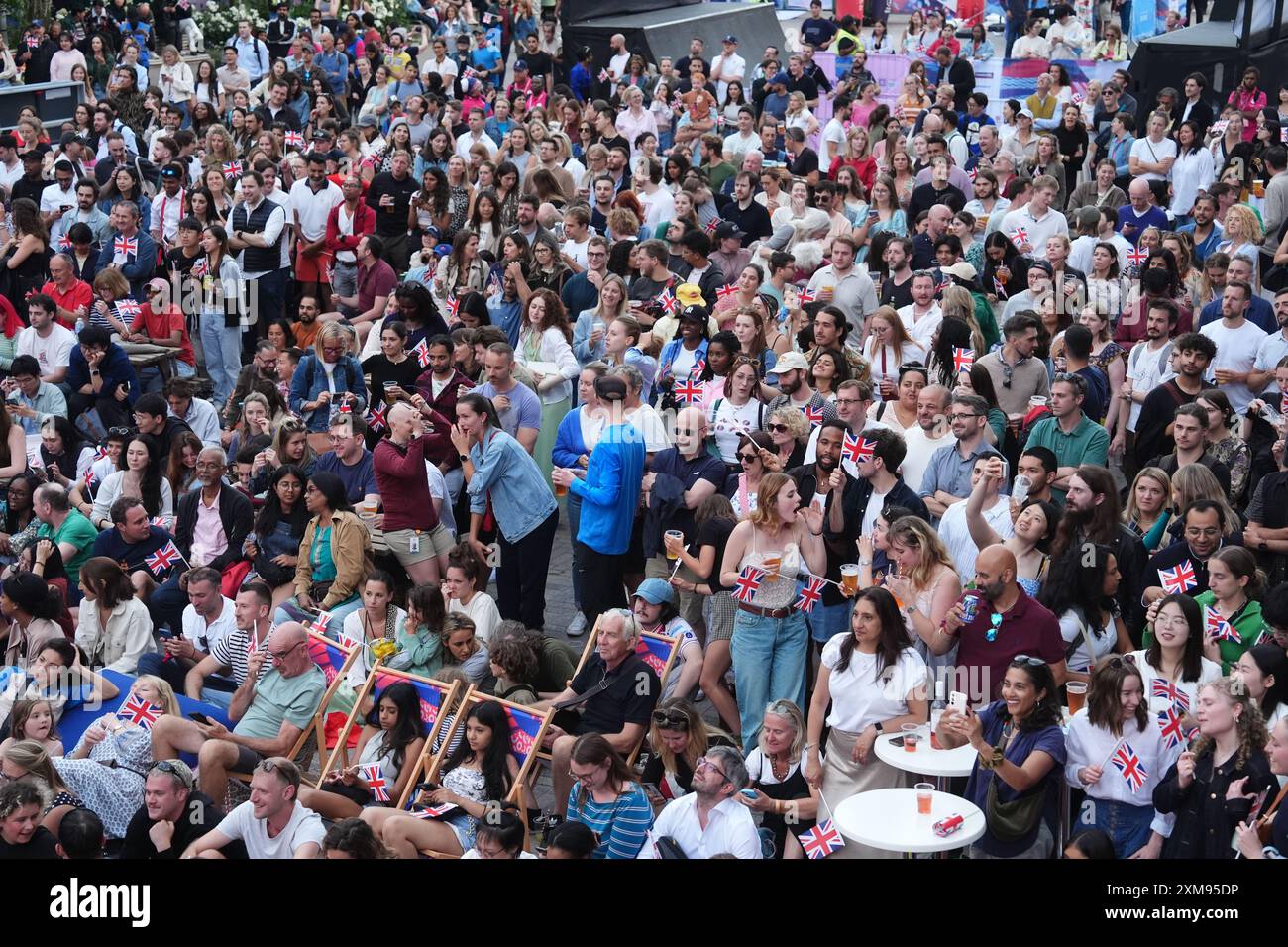 Fans watch the opening ceremony of the Paris 2024 Olympic Games on a ...