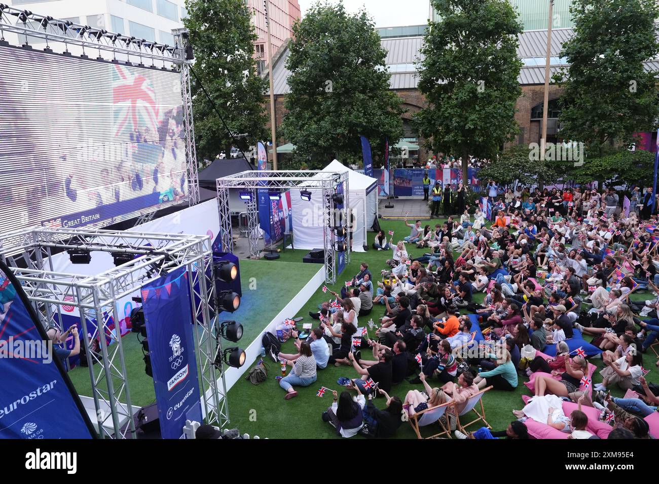 Fans watch the opening ceremony of the Paris 2024 Olympic Games on a ...