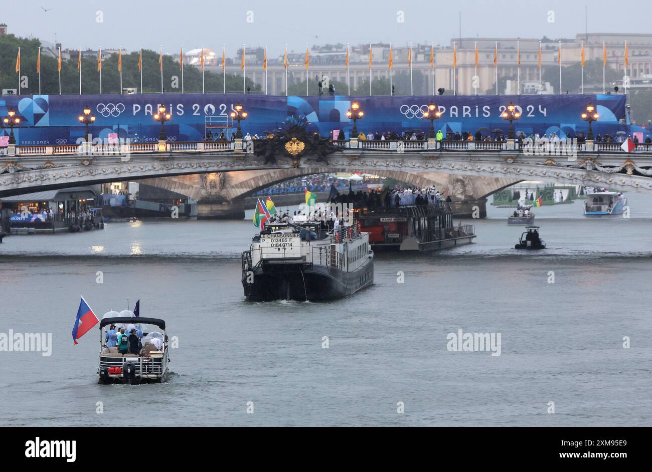 Paris, France. 26th July, 2024. Boats carrying athletes travel on the ...