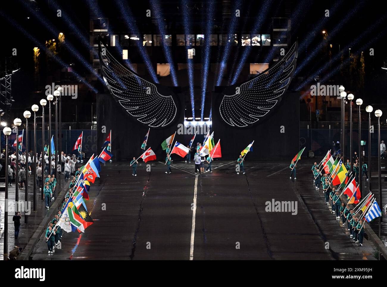 Volunteers carrying the flags of competing nations at the Trocadéro ...
