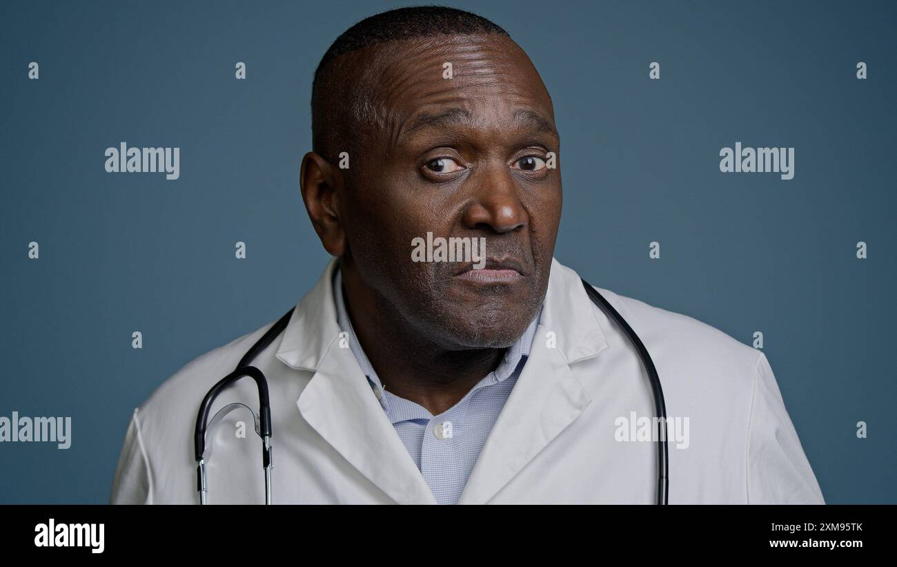 Close-up unsure confused ethnic african american man doctor surgeon in ...