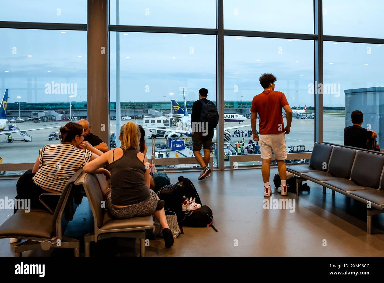 Travelers wait for their Ryanair plane in London Stansted Airport ...