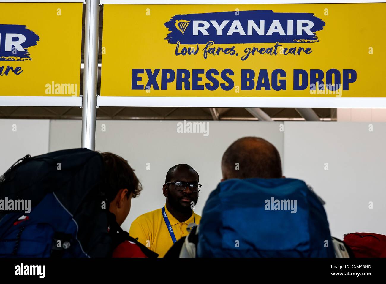 Passangers wait at self check-in and self bag drop is seen at Ryanair ...