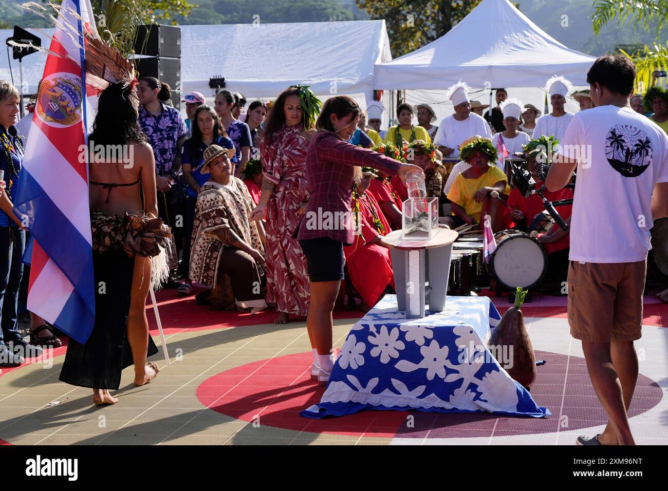 Brisa Hennessy, of Costa Rica, adds sand from a beach in Costa Rica to ...