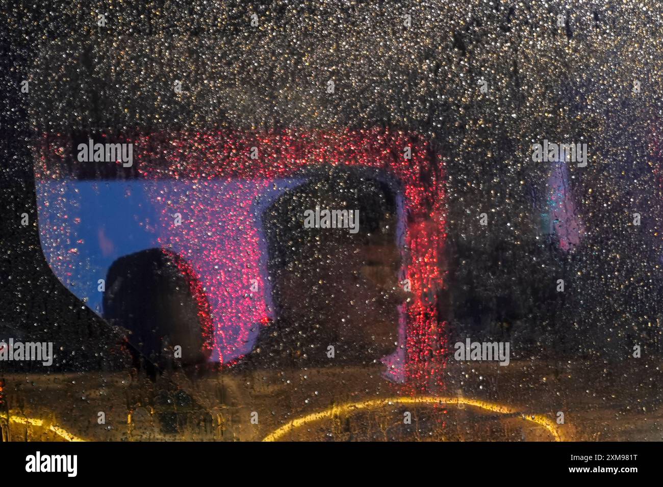 A French police officer is seen through the windshield of a police van ...