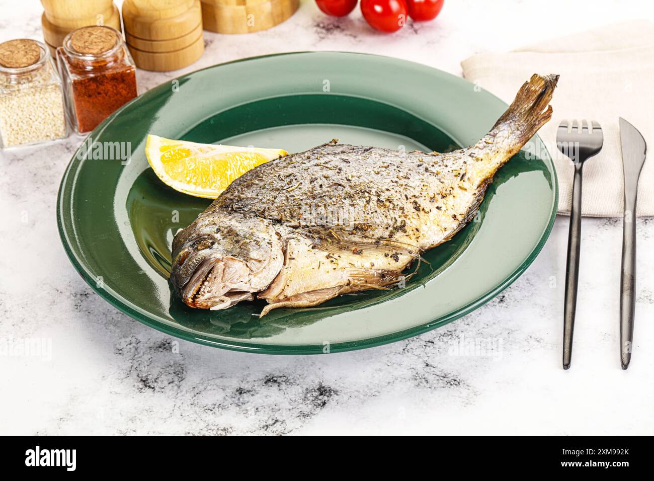 Baked Dorado fish served lemon slice Stock Photo - Alamy