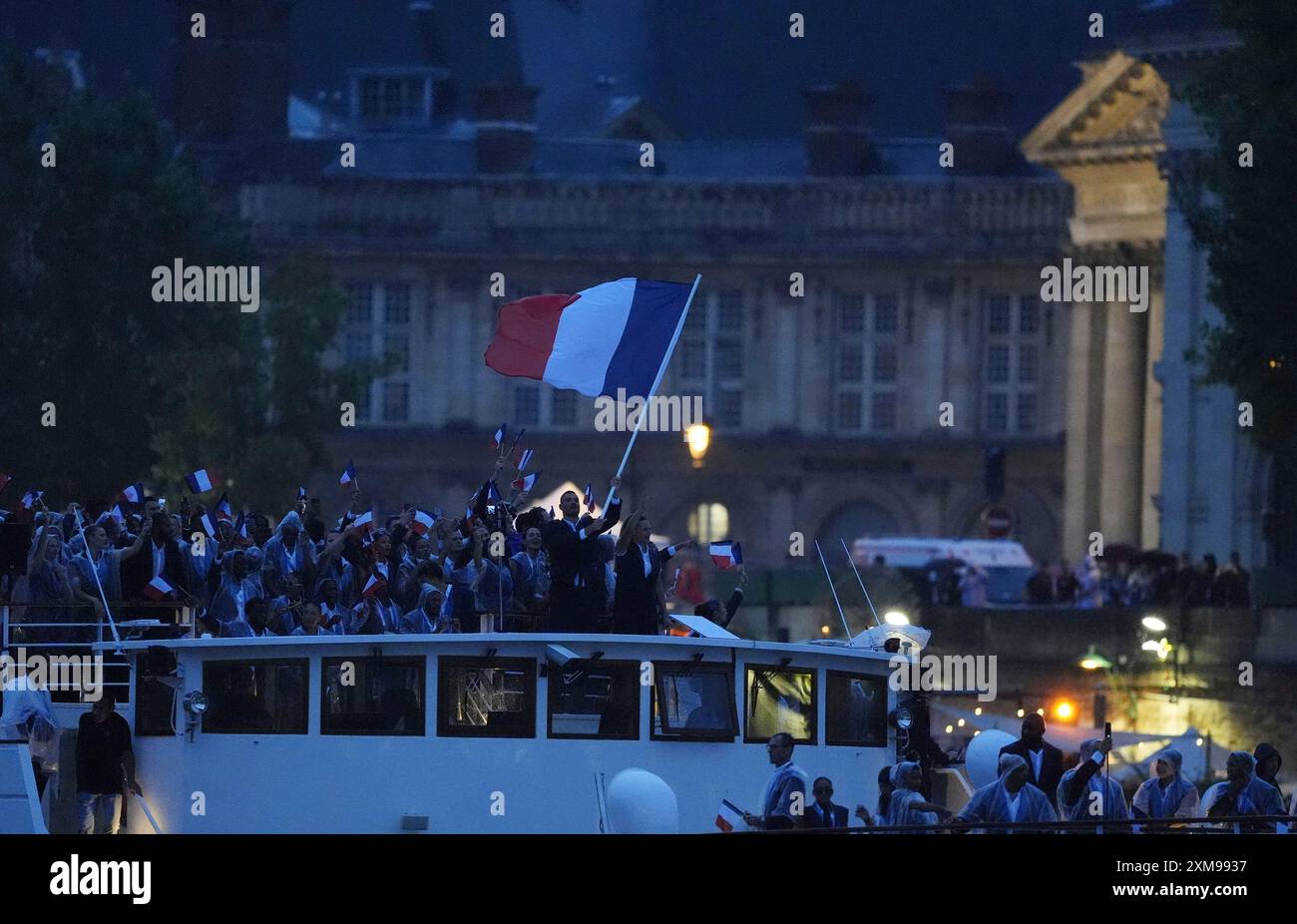 France's athletes aboard a boat sail the River Seine during the opening ...