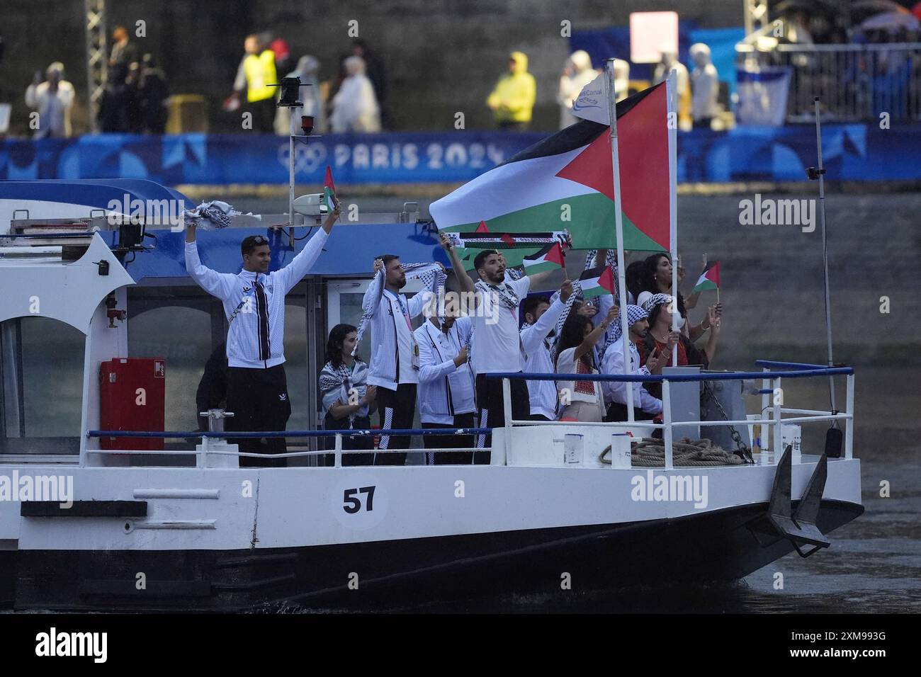Palestine's athletes aboard a boat sail the River Seine during the ...