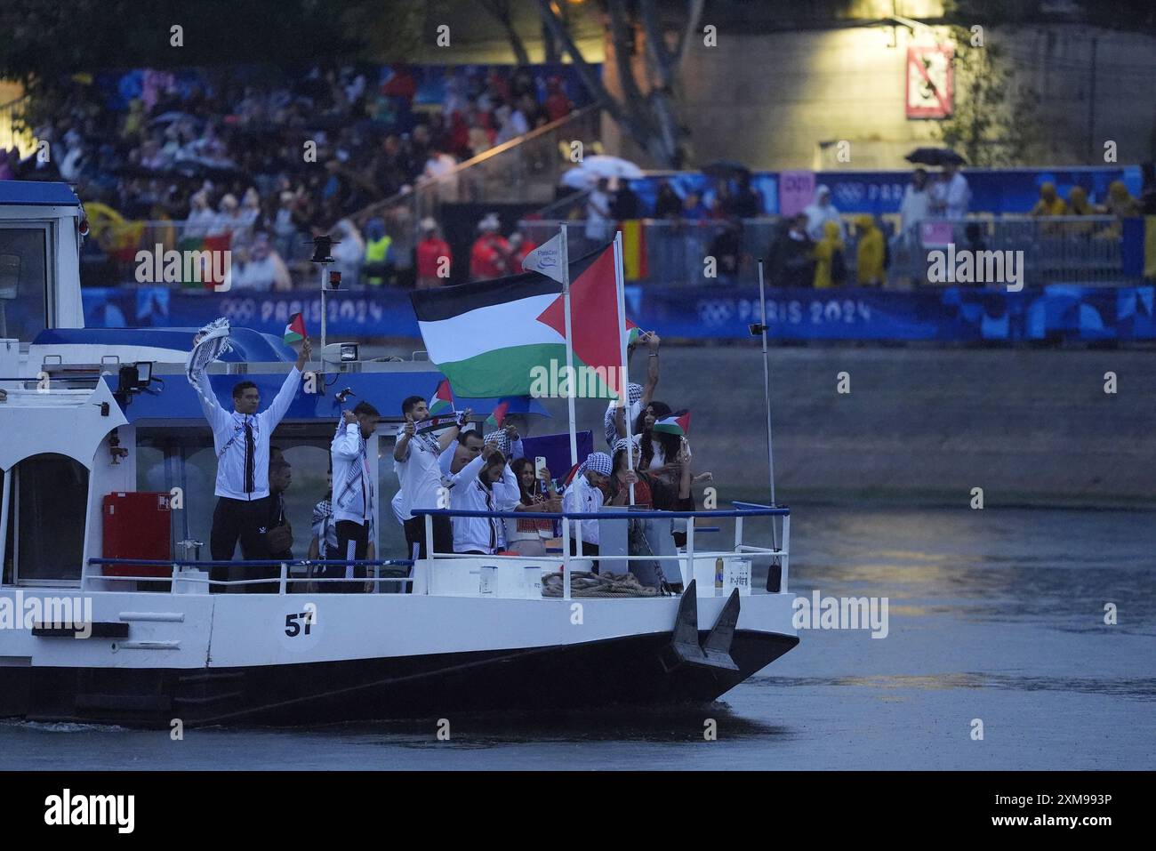 Palestine's athletes aboard a boat sail the River Seine during the ...