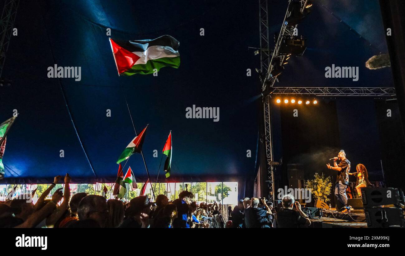 Malmesbury, UK. 26th July, 2024. Palestinian supporters wave flags as ...