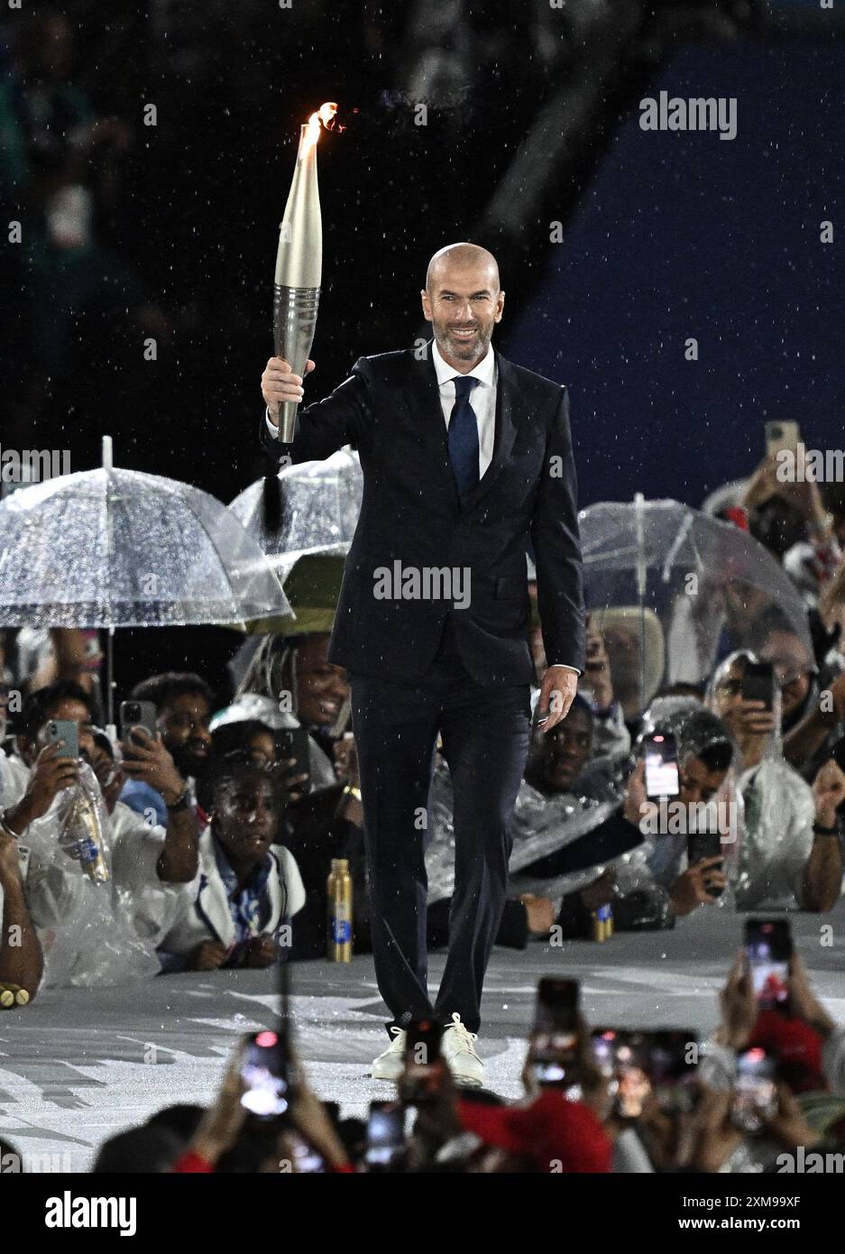 Paris, France. 26th July, 2024. Zinédine Zidane carries the Olympic ...