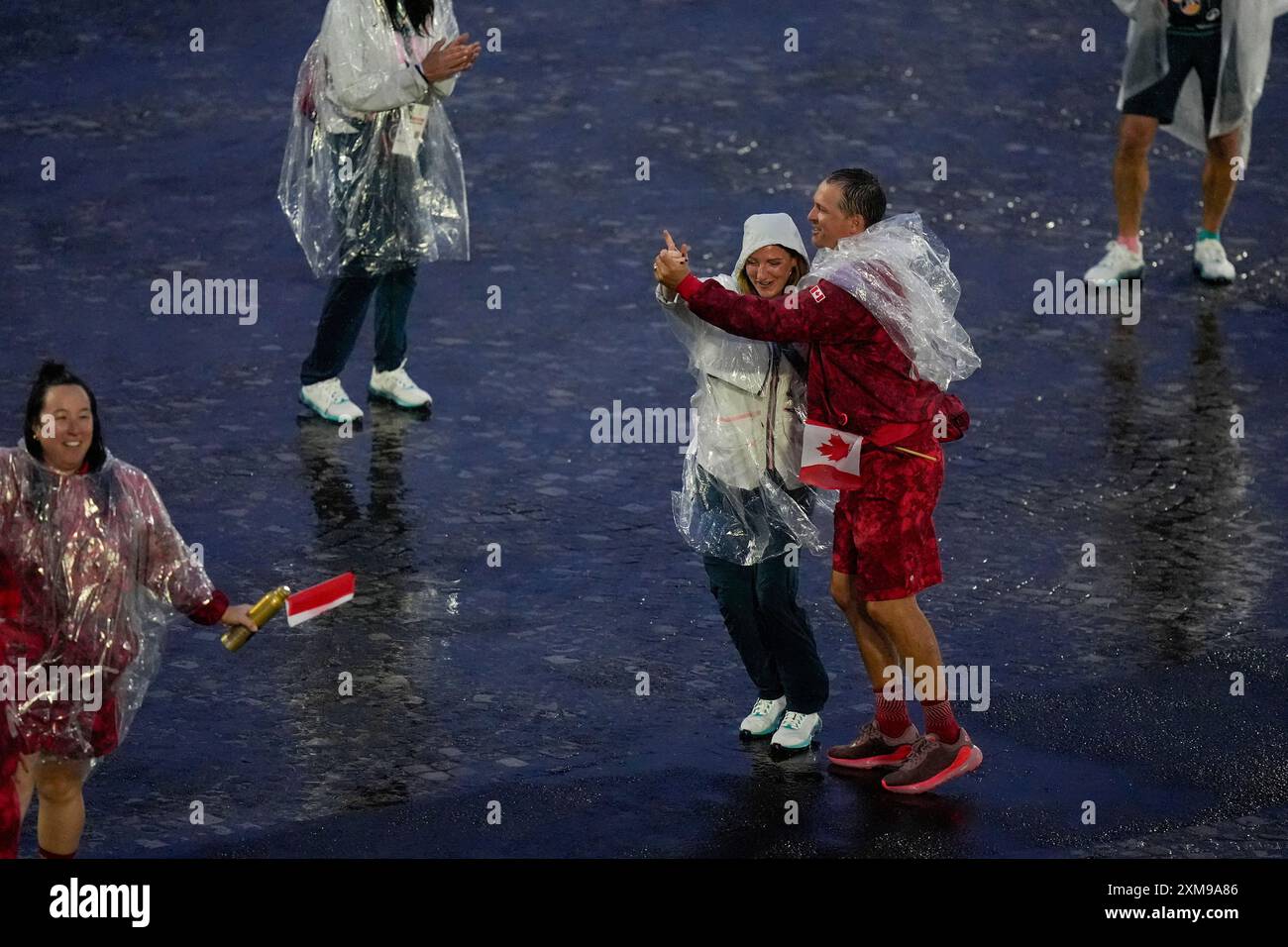 A member of Team Canada dances with an Olympic staff member in Paris ...