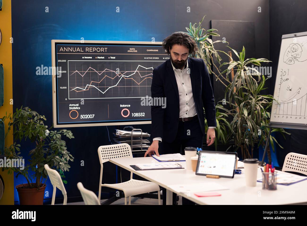 Administrator preparing the boardroom for an important meeting with his ...