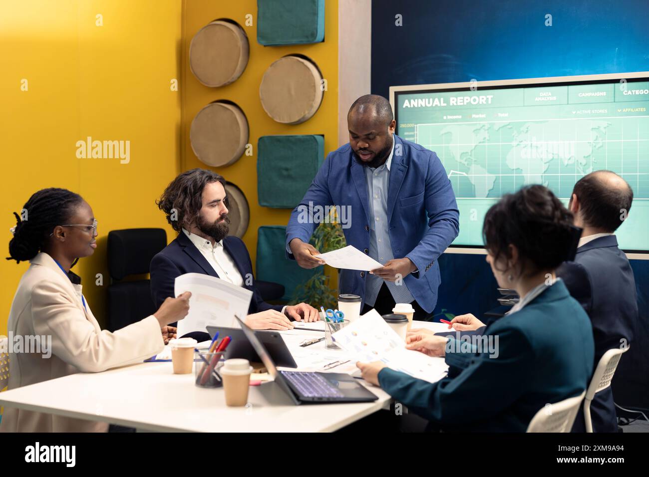 Business associates reviewing key performance indicators within the ...