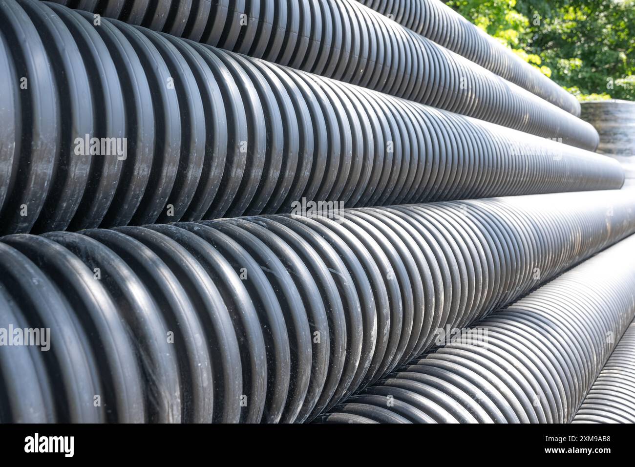 Stack of black HDPE storm sewer pipe (HDPE plastic N-12) on a project ...