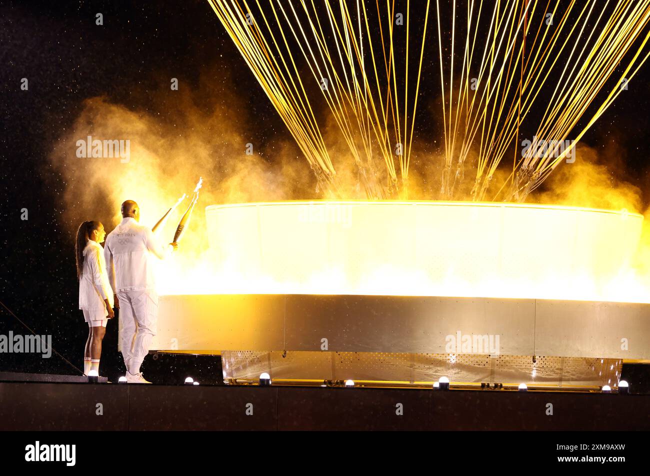 The Olympic flame is lit during the opening ceremony of the Paris 2024 ...