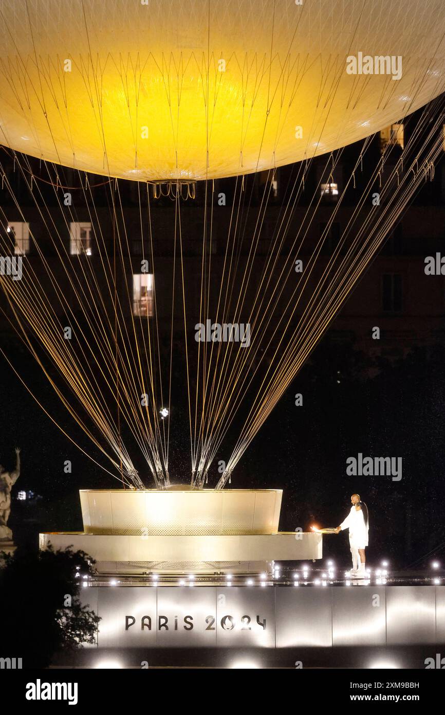 The Olympic flame is lit by Marie-Jose Perec and Teddy Riner during the ...