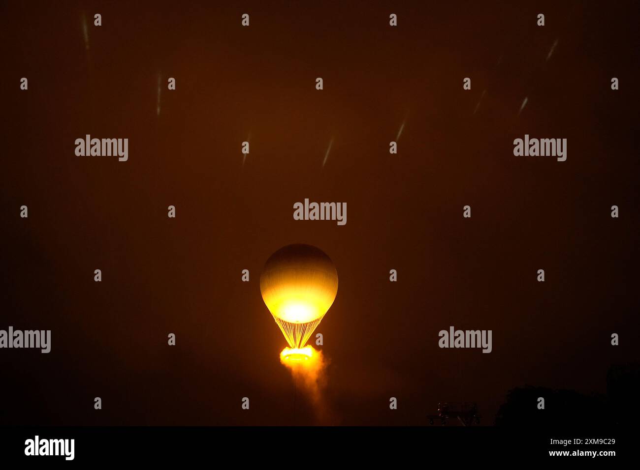 The Olympic Flame rises on a balloon after being lit in Paris, France ...