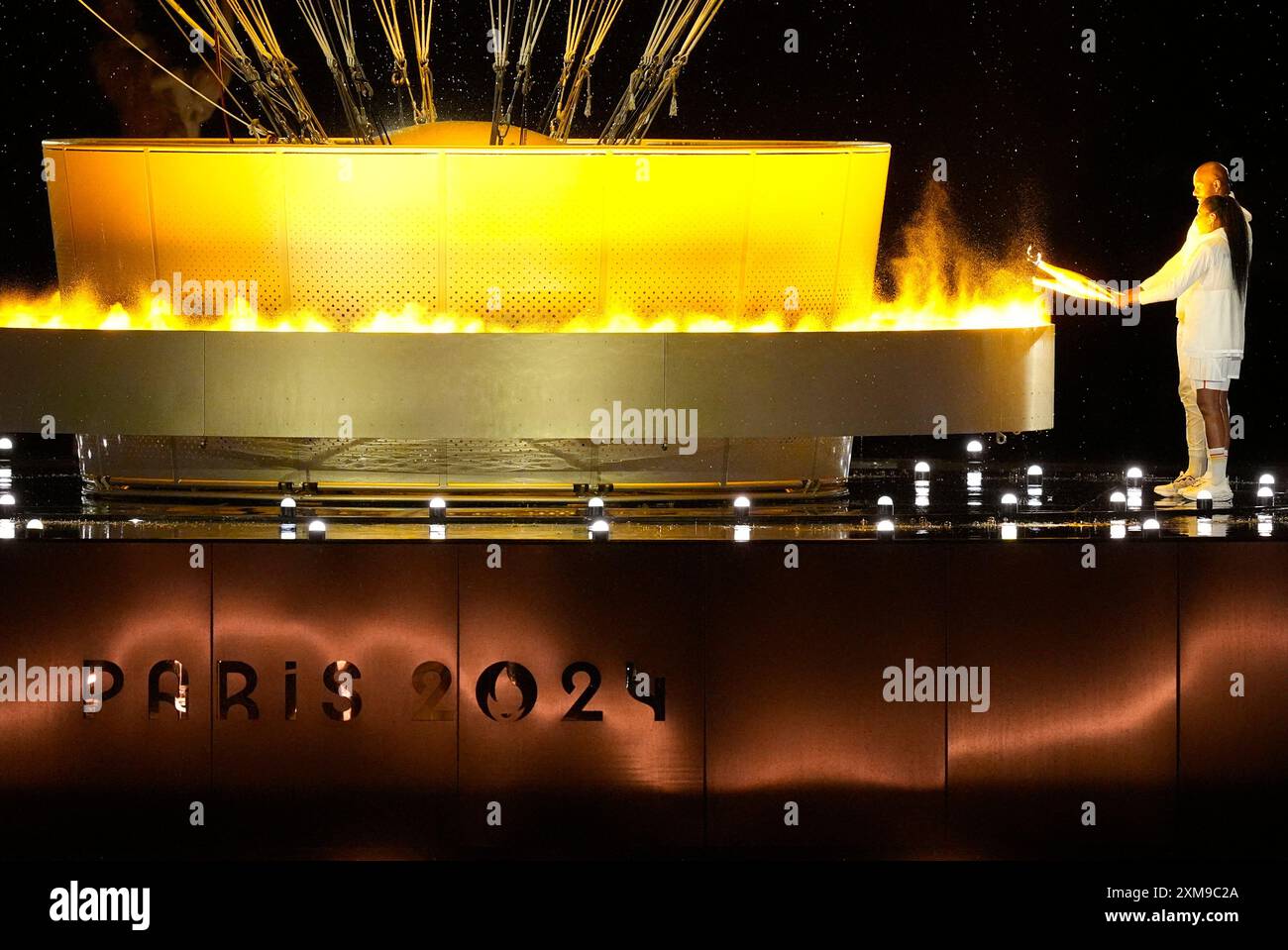 The cauldron is lit by torch bearers Marie-Jose Perec and Teddy Riner ...